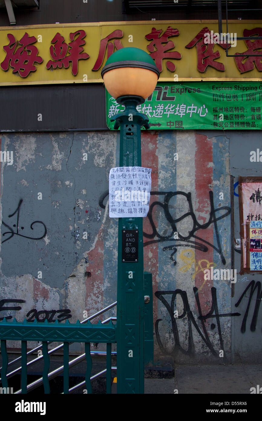 Chinese letters adorn signs at Grand Street subway station in Chinatown ...