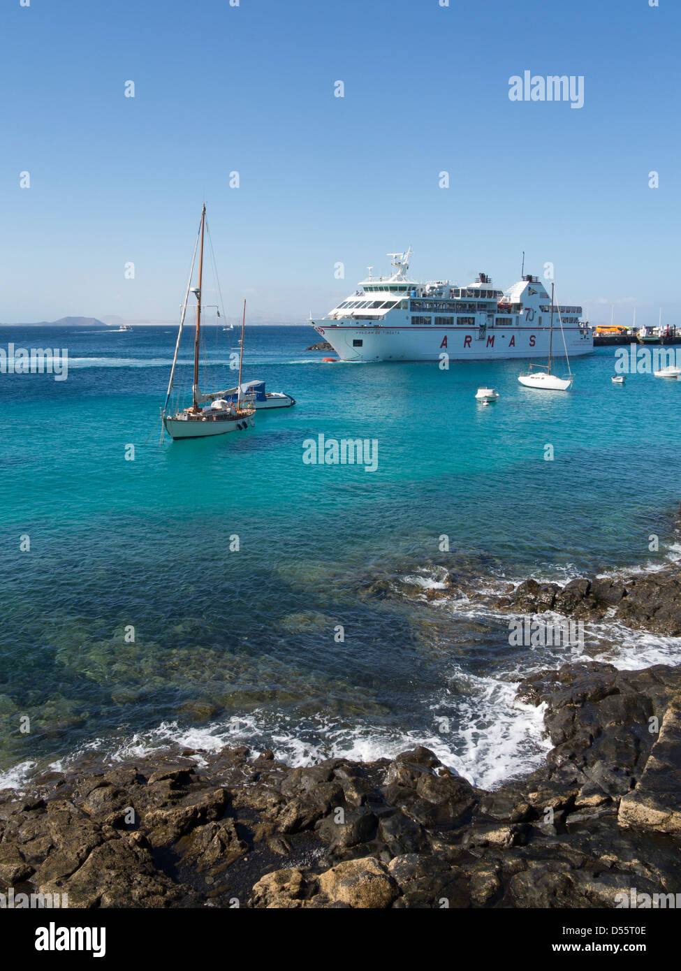 Armas ferry and moored boats in Playa Blanca Harbour, Lanzarote with ...