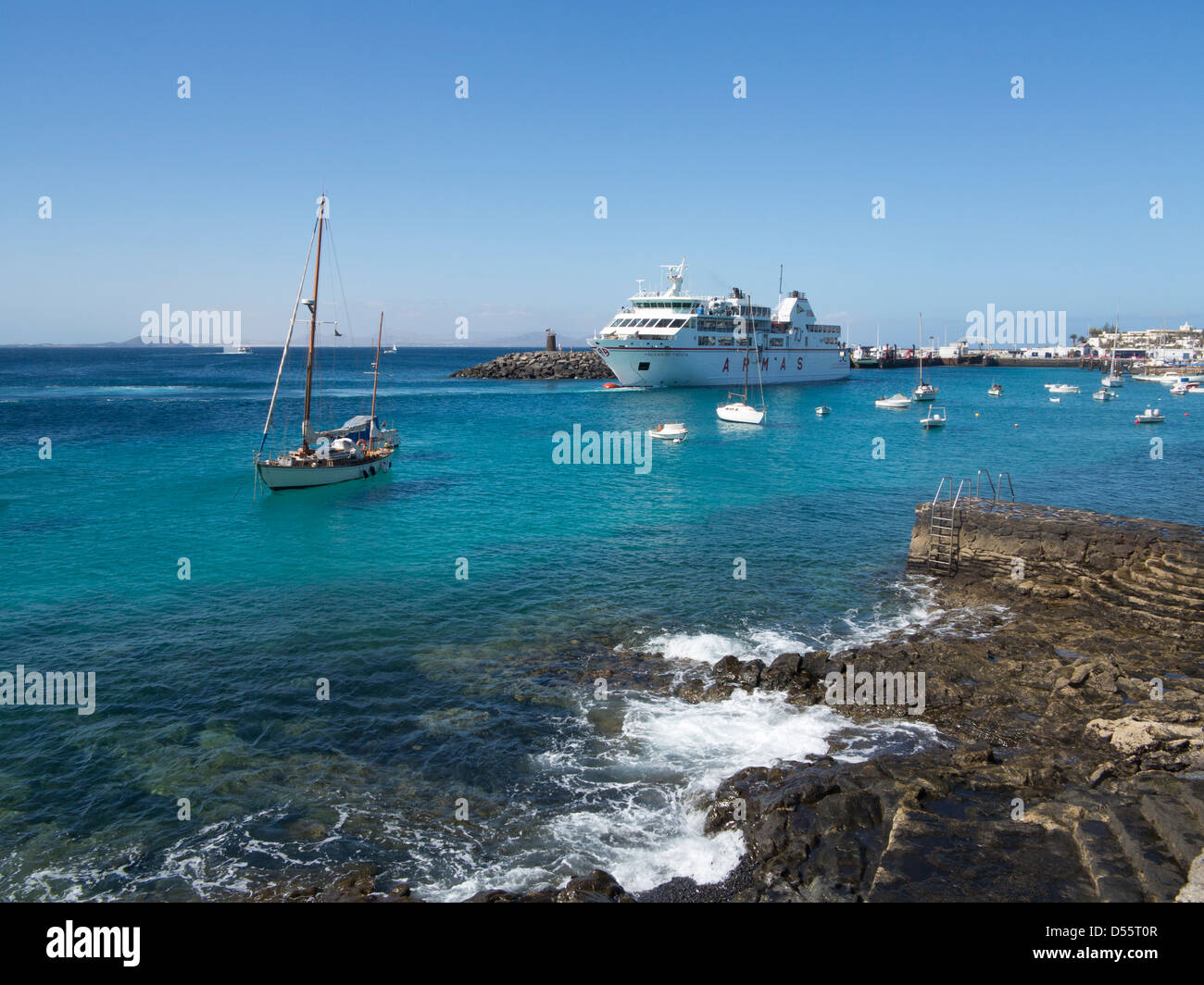 Armas ferry and moored boats in Playa Blanca Harbour, Lanzarote with ...