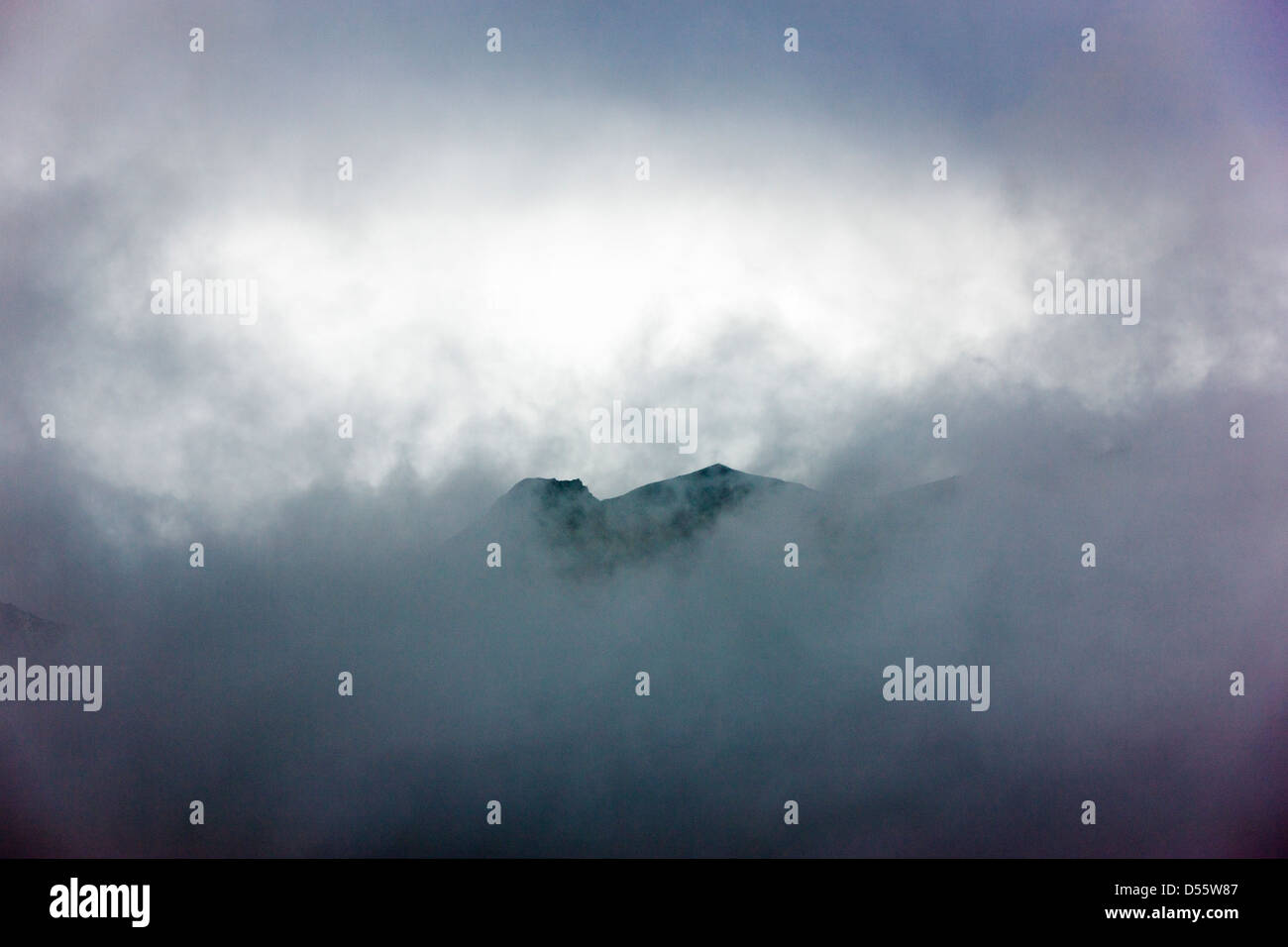 Low clouds, mist and fog partially obscure the Alaska Range, Denali ...