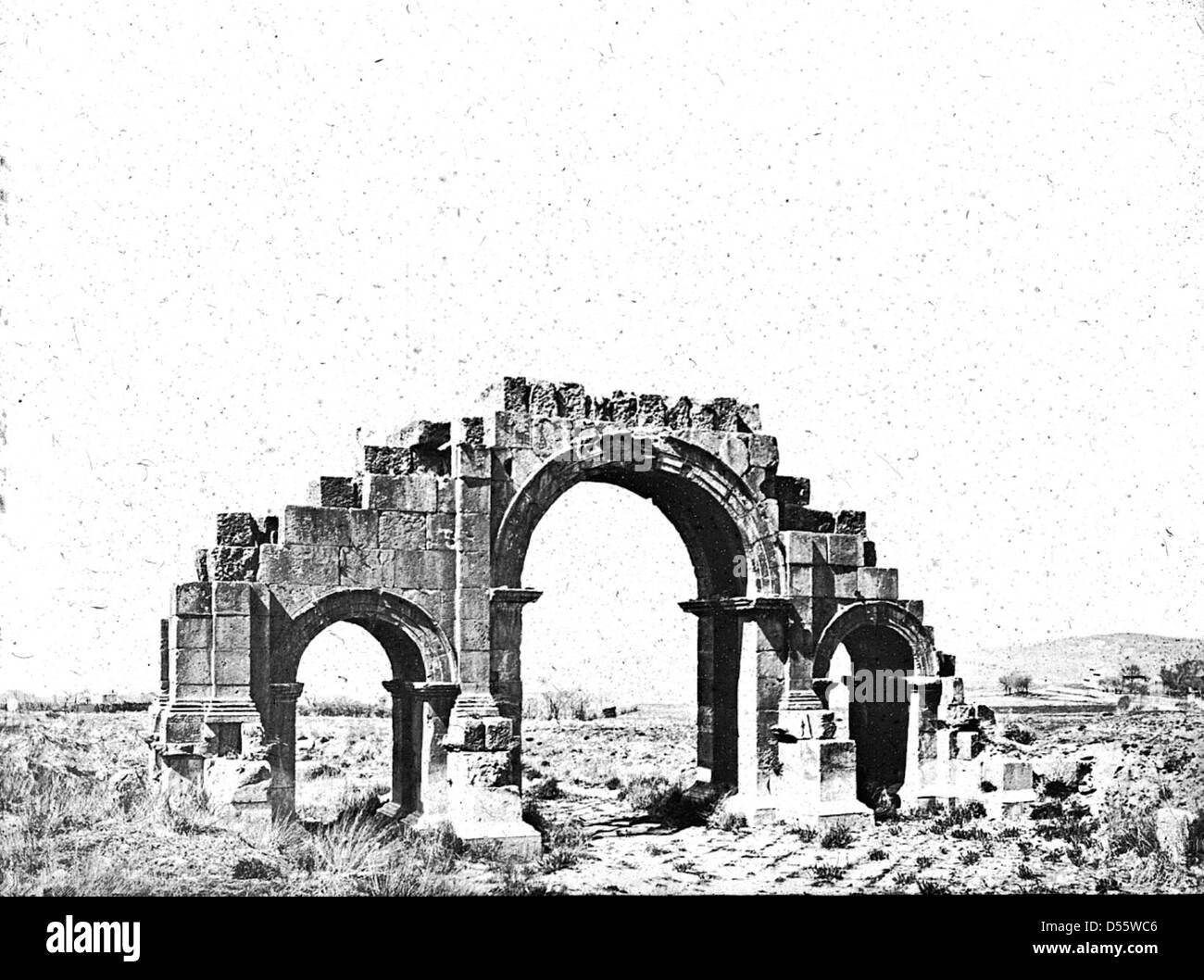 A black and white photograph of a Roman arch in Constantium (modern-day ...
