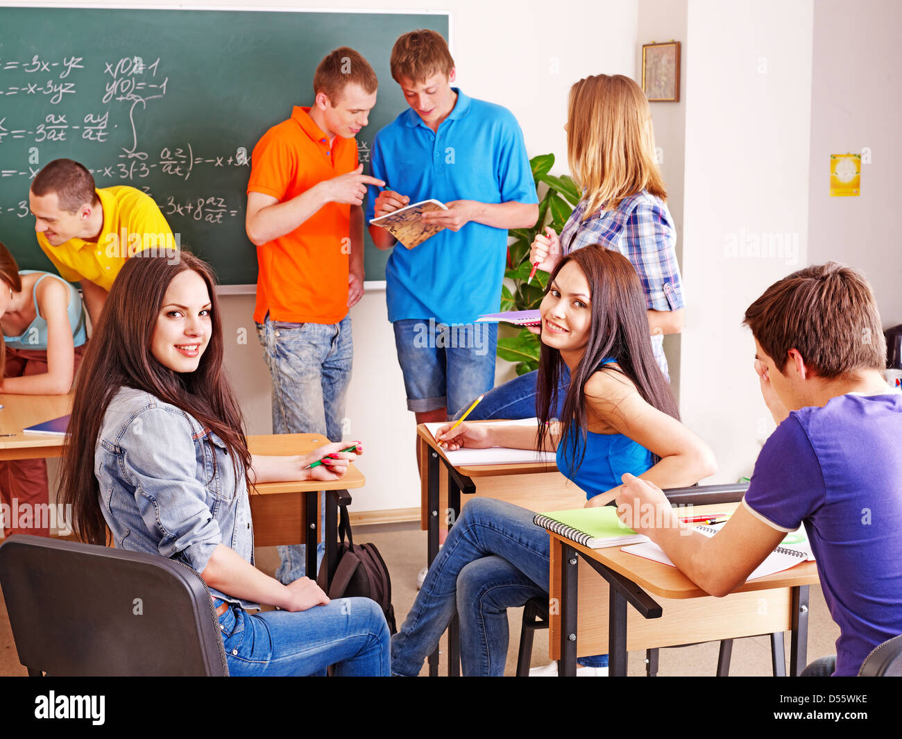 Group happy student in classroom near blackboard Stock Photo - Alamy