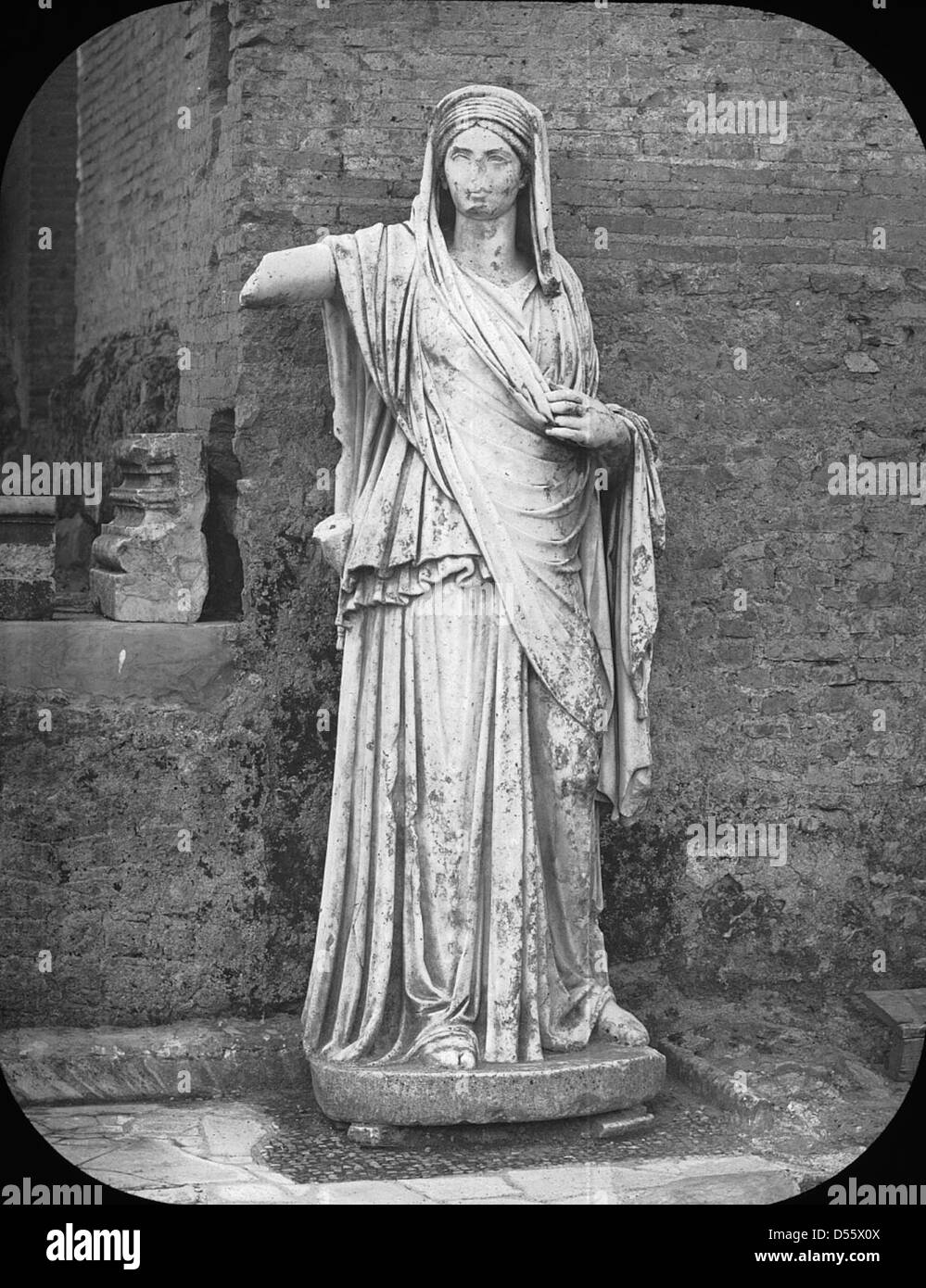 This photograph shows the statue of a Vestal Virgin in the Atrium ...