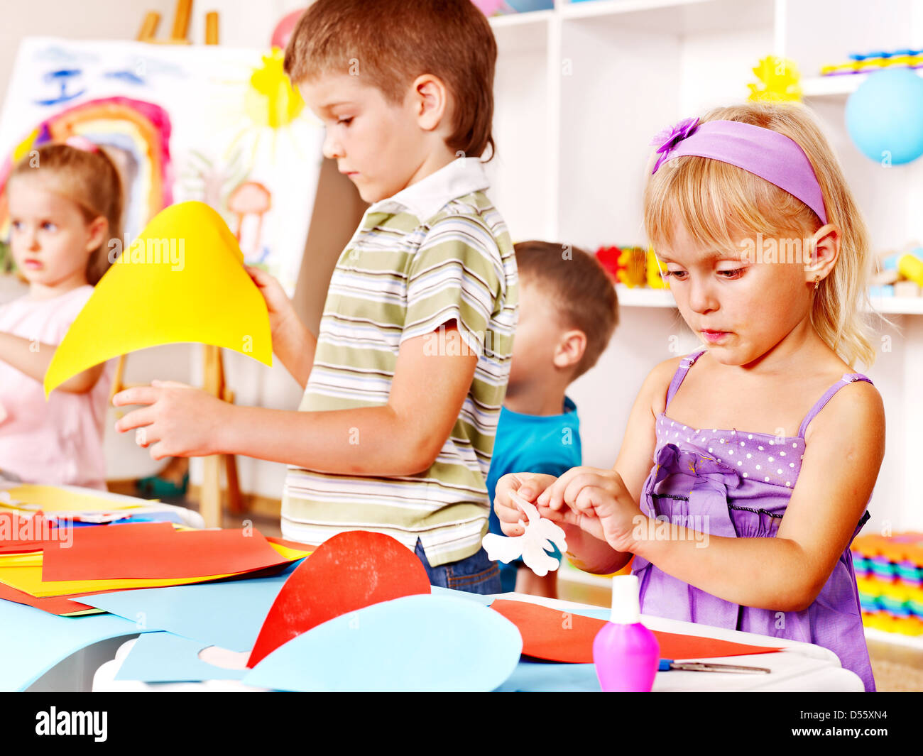 Child boy cutting out scissors paper in preschool Stock Photo - Alamy