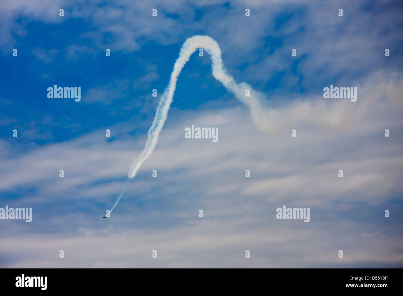acrobatic airplane doing acrobatics with the smoke on the sky Stock ...