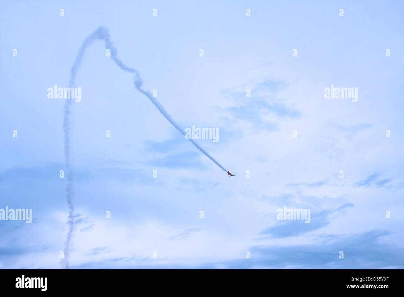 acrobatic airplane doing acrobatics with the smoke on the sky Stock ...