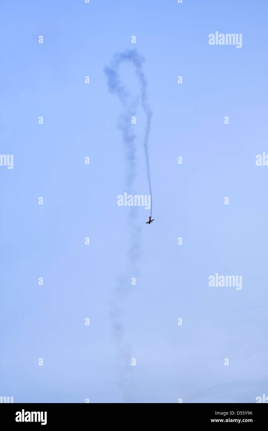 acrobatic airplane doing acrobatics with the smoke on the sky Stock ...