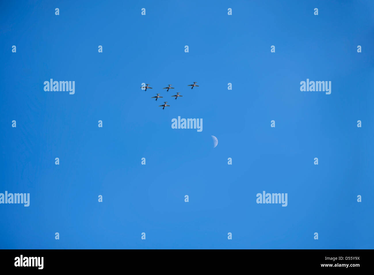 Aircraft squadron flying around the moon in triangle formation Stock ...