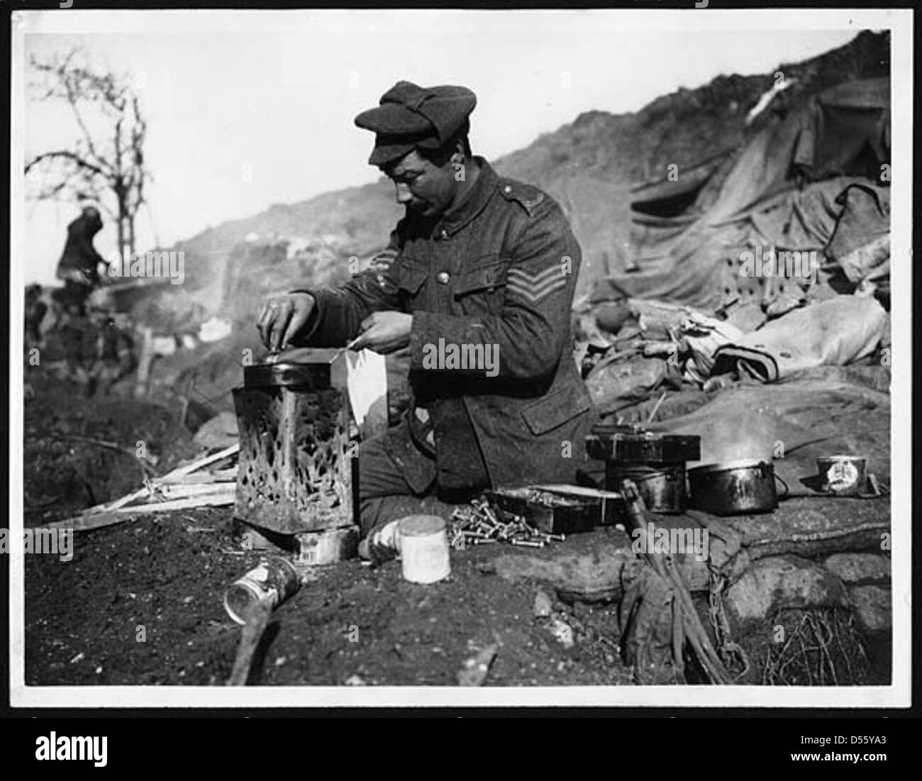 A World War I sergeant is seen preparing his dinner during a break from ...