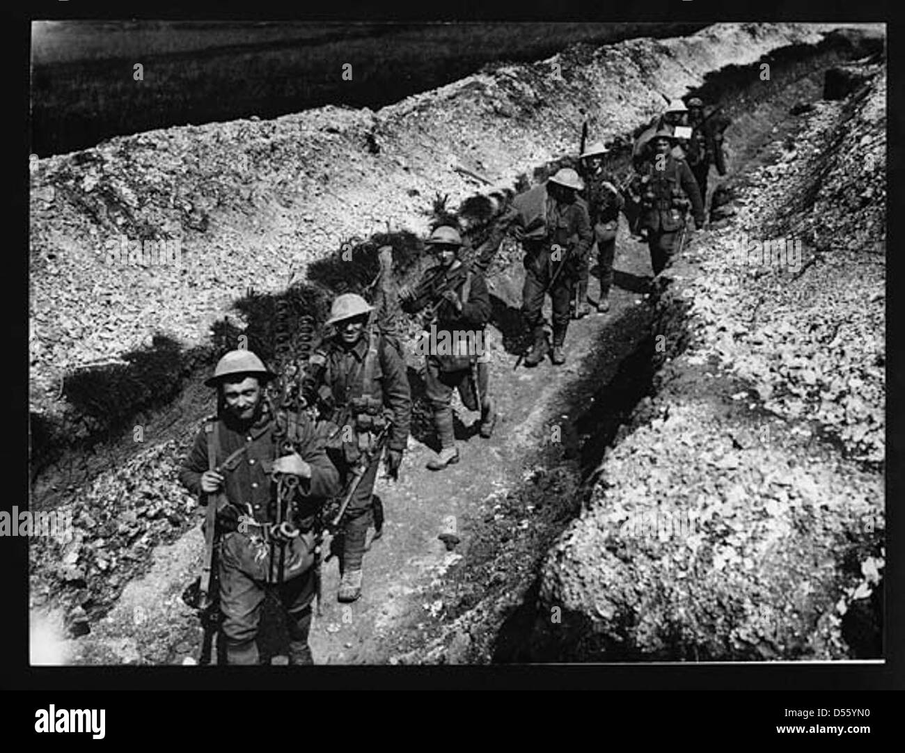 Troops in steel helmets moving along a communication trench fully ...