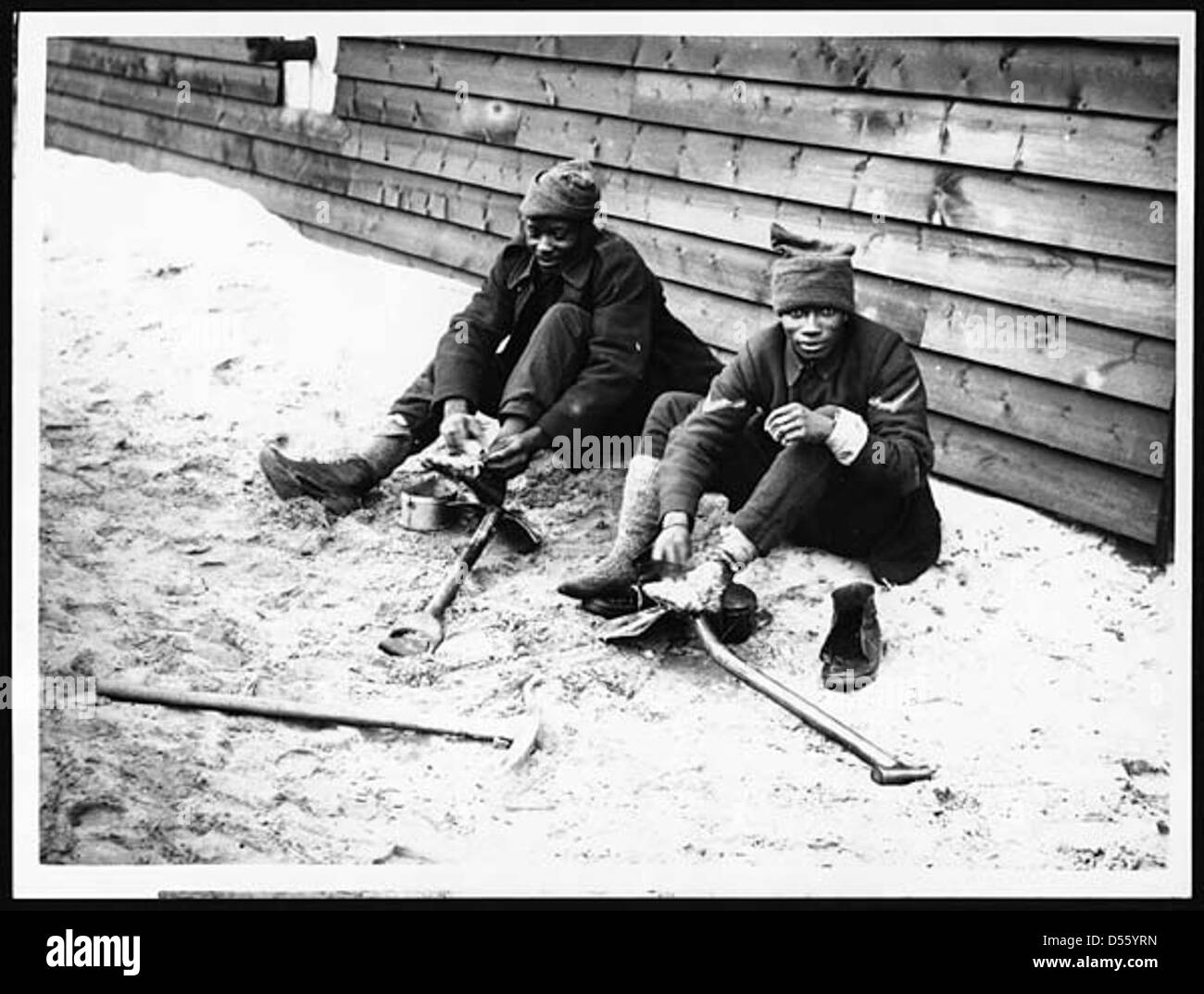 Two young soldiers grease their feet before heading to the front during ...