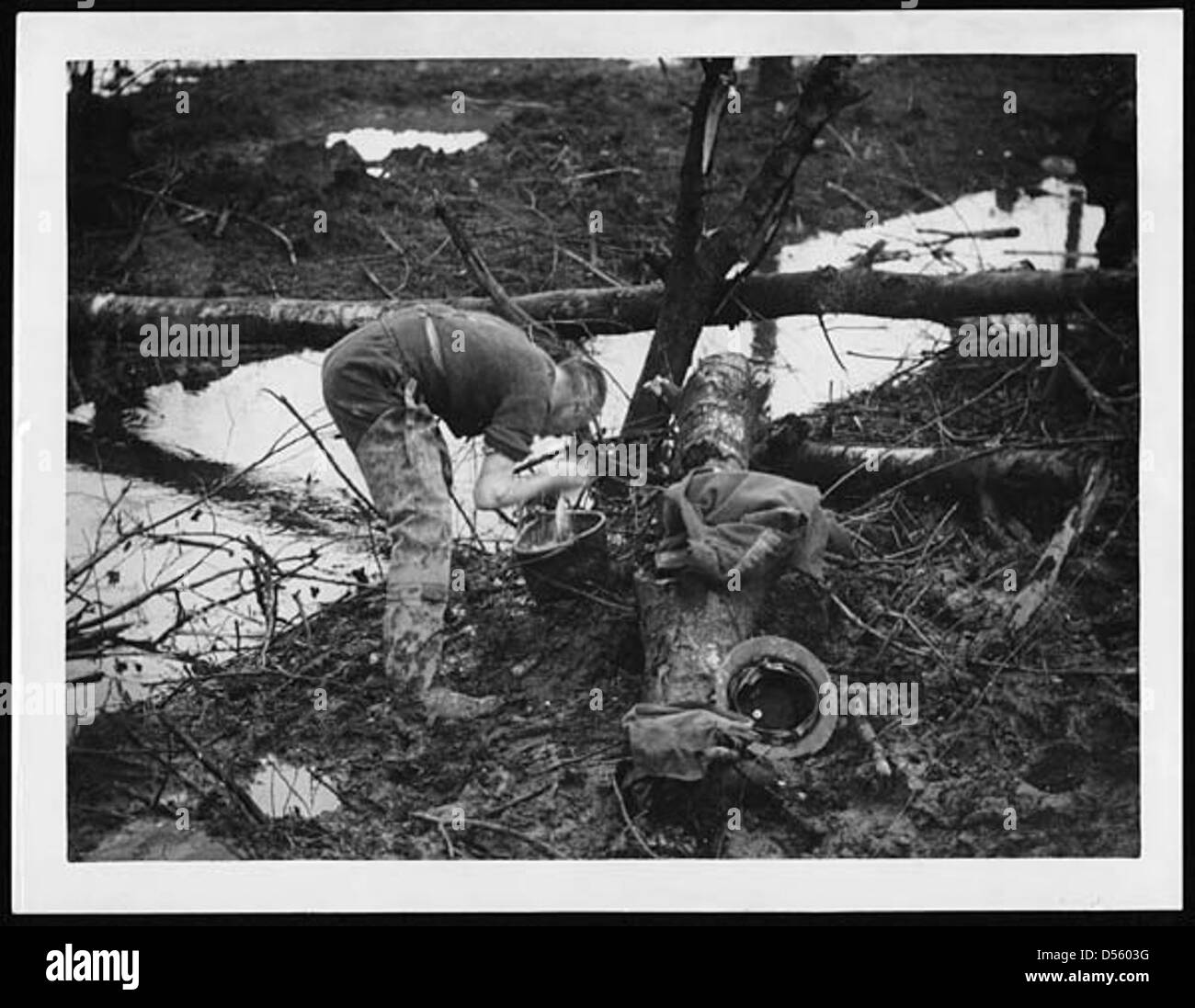 A soldier (Tommy) performs his personal hygiene in the trenches ...