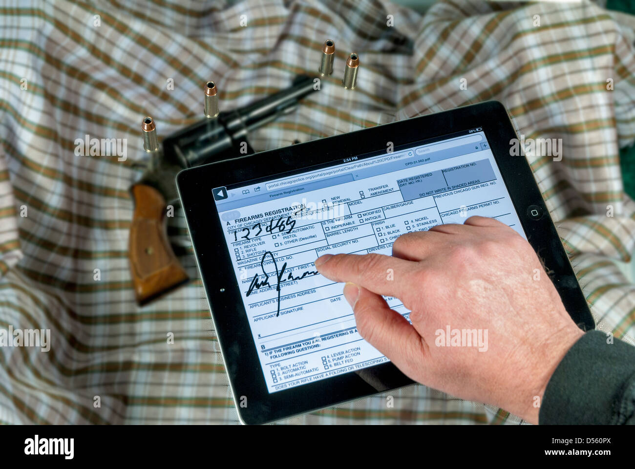 Using an Ipad to fill out a gun registration form Stock Photo - Alamy