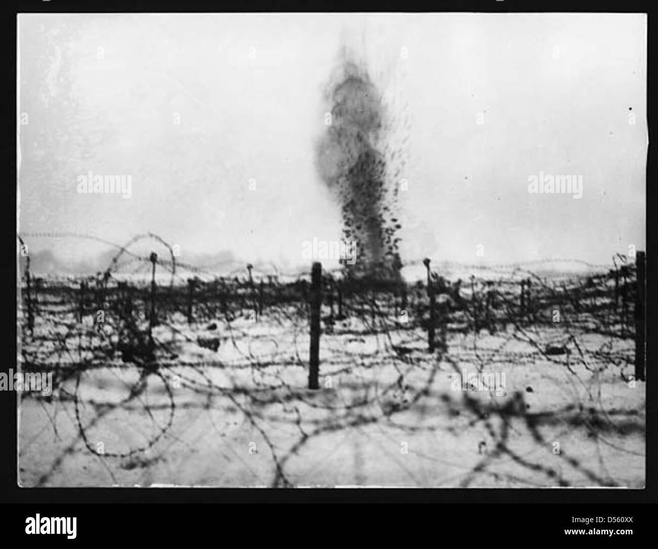 A dramatic photograph showing a shell bursting over a front-line trench ...
