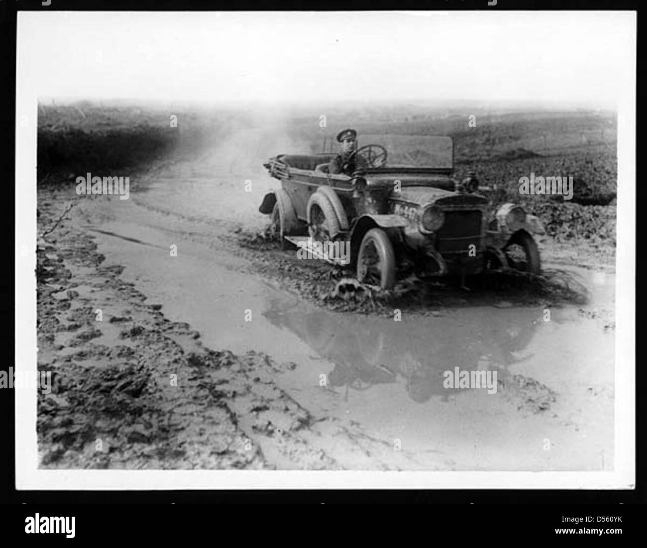 A road damaged by the conditions of war during World War I. Poorly ...