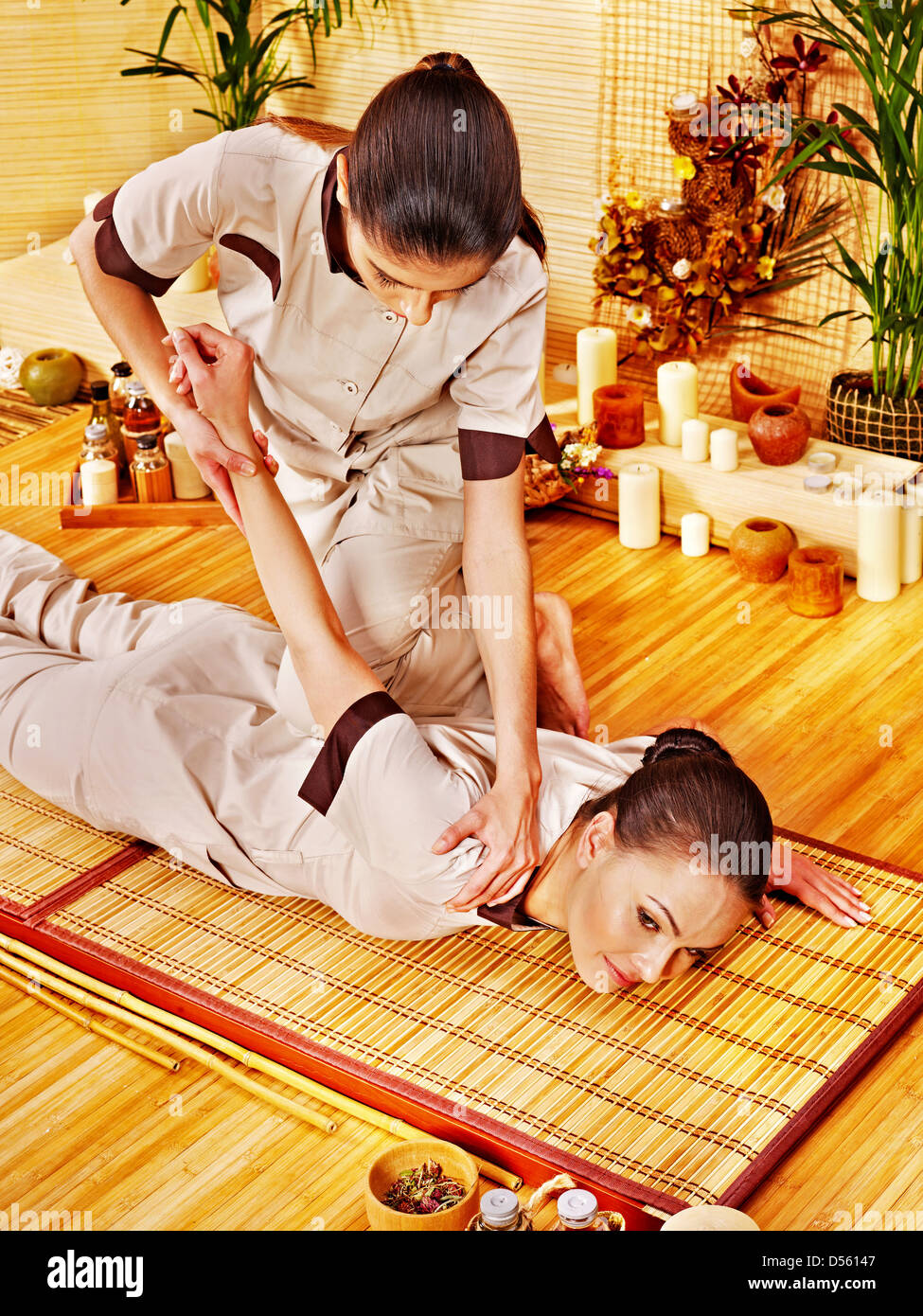 Therapist giving Thai stretching massage to woman Stock Photo - Alamy