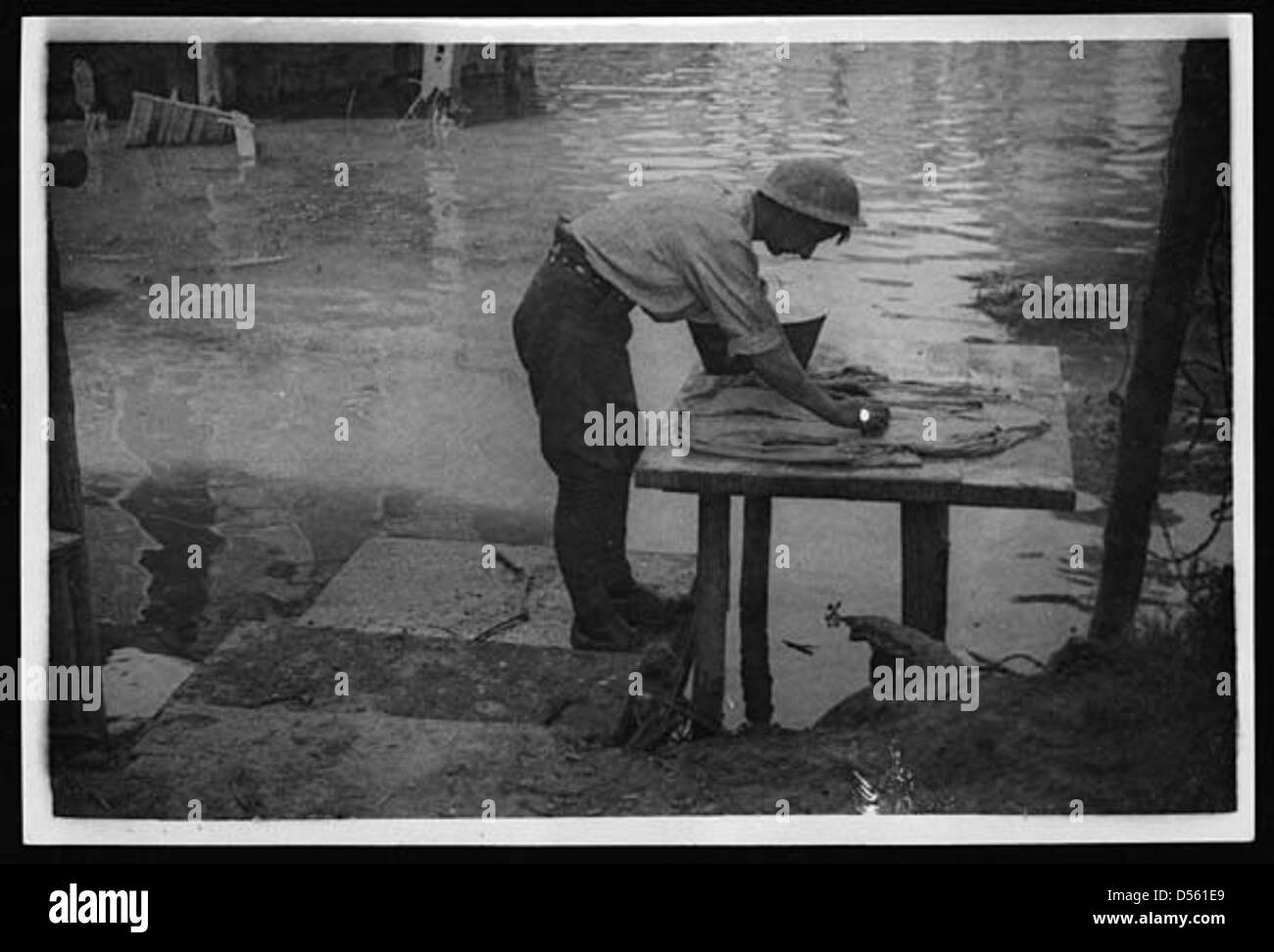Soldiers wash clothes on the banks of the Scarpe River during World War ...