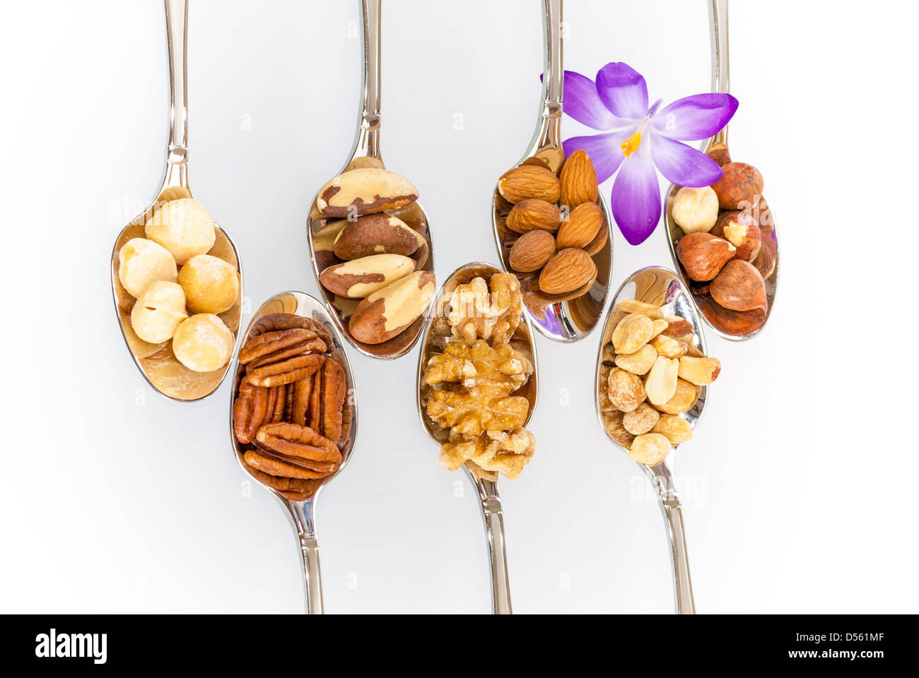 Healthy nuts in serving spoons Stock Photo - Alamy