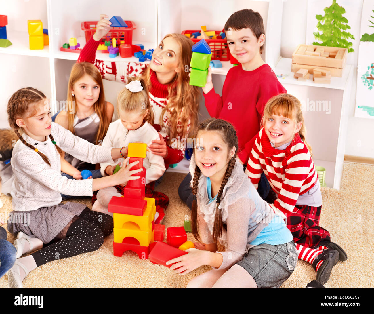 Children in kindergarten stacking block Stock Photo - Alamy