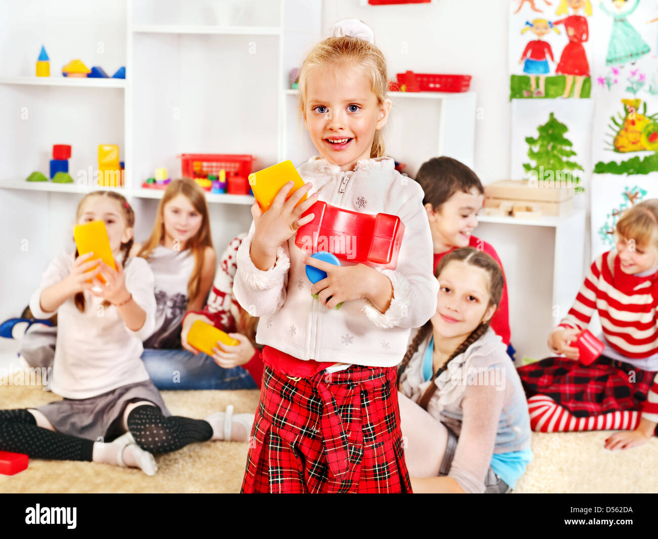 Children in kindergarten stacking block Stock Photo - Alamy