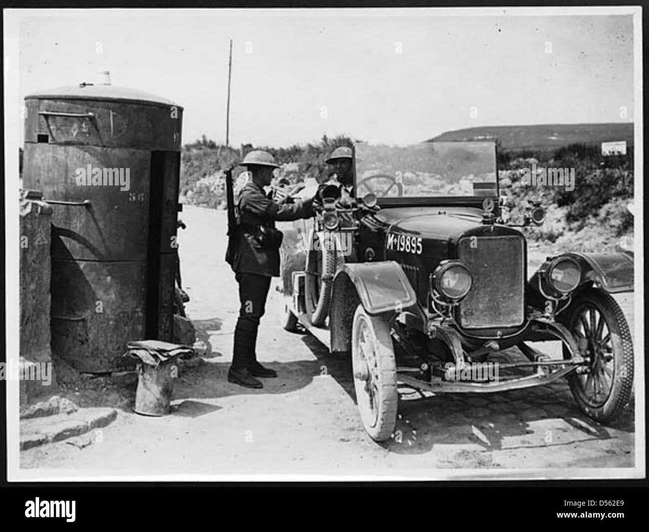 A British officer examines a forward post in the trenches during World ...