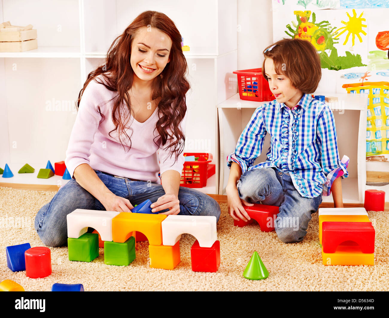 Family with children playing bricks Stock Photo - Alamy