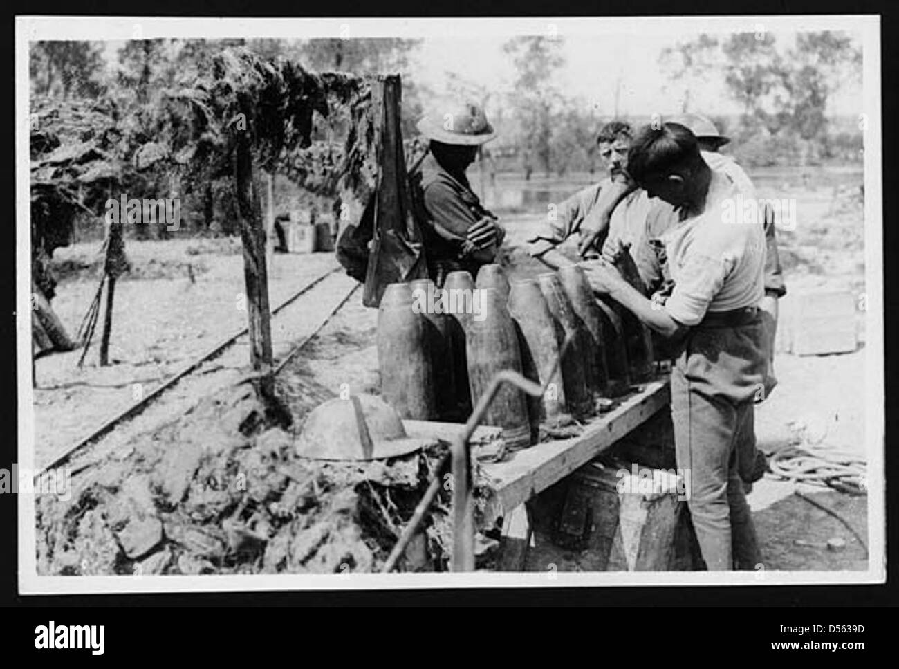 Gunners are seen setting time fuses for artillery shells during World ...