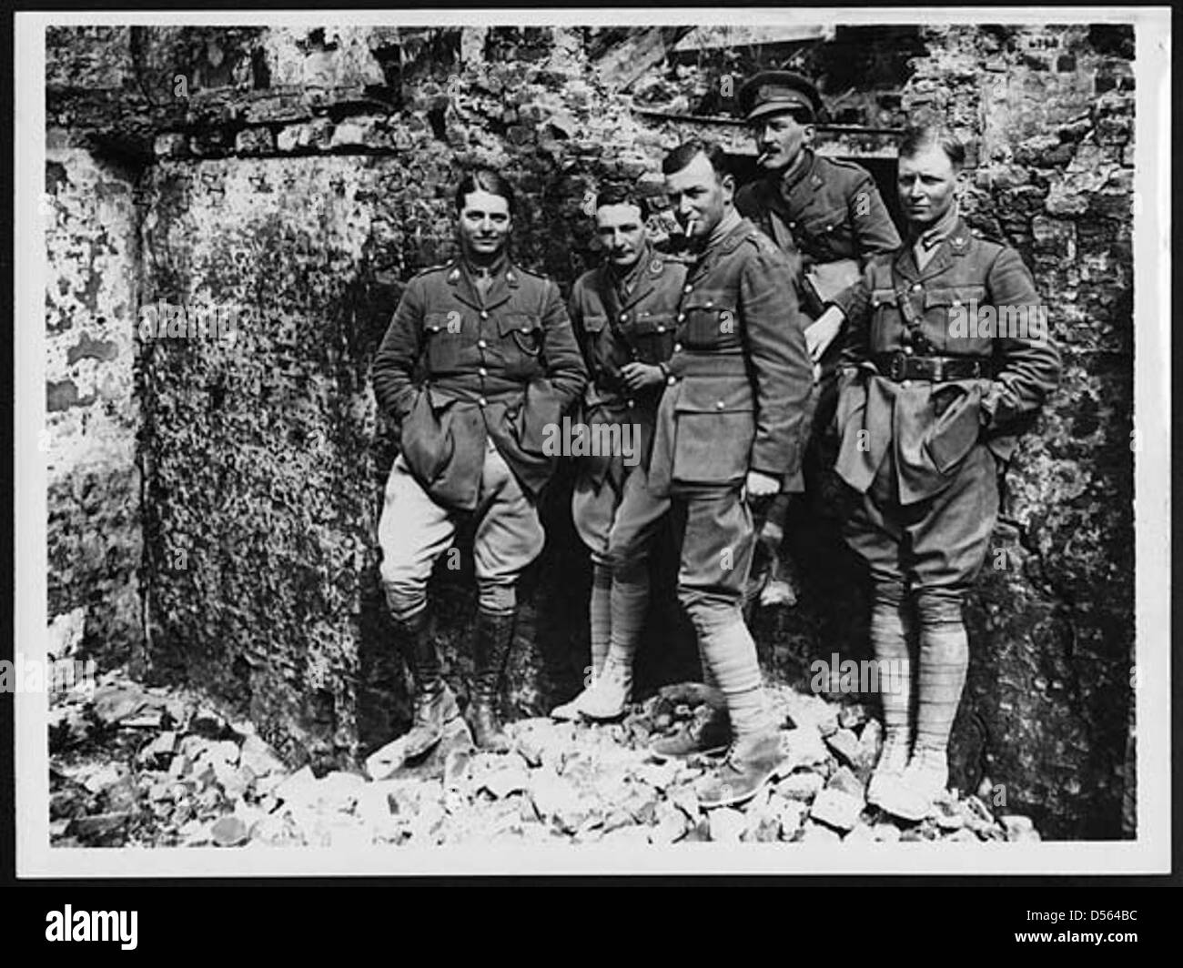 Officers surveying a wrecked house during World War I, reflecting the ...