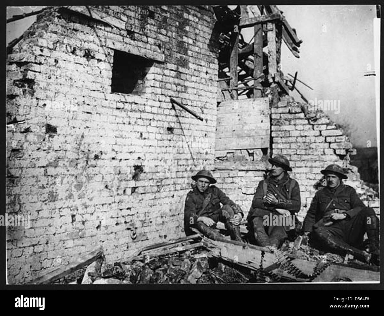 Officers rest in a corner of a wrecked building during World War I ...