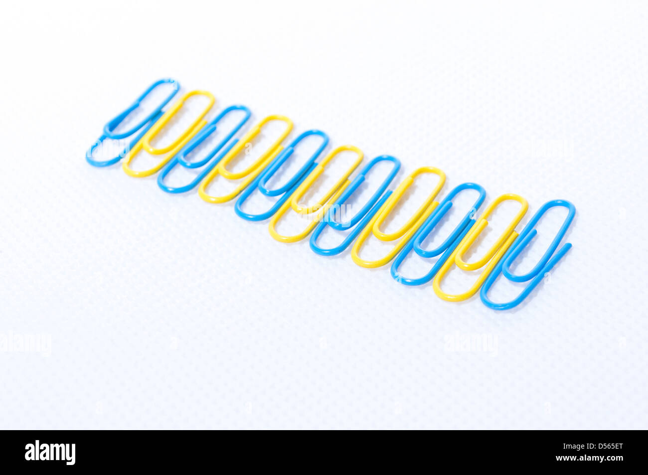 yellow and blue paper clips on the white background Stock Photo - Alamy