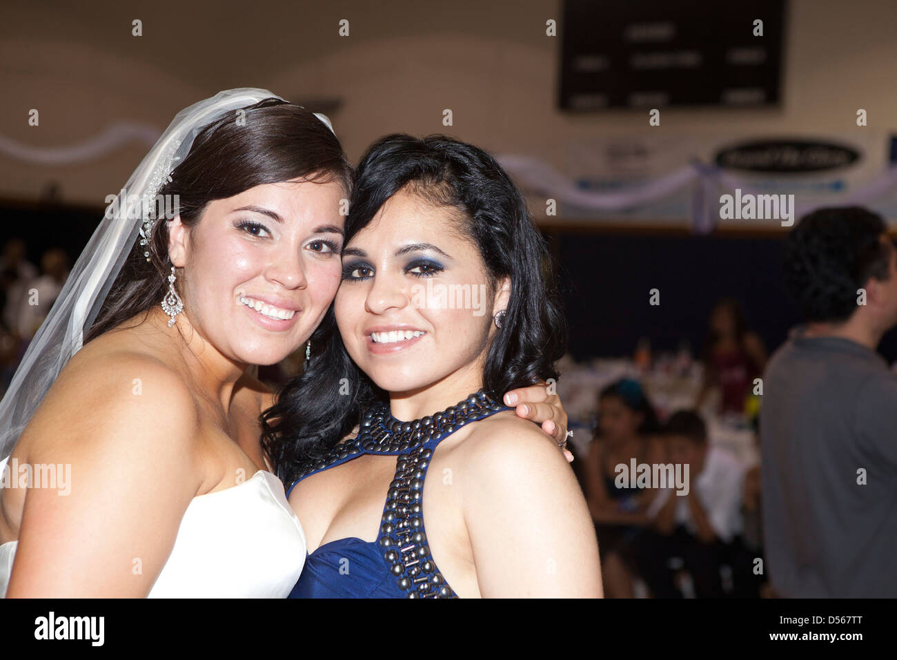 Hispanic bride hugging friend Stock Photo - Alamy
