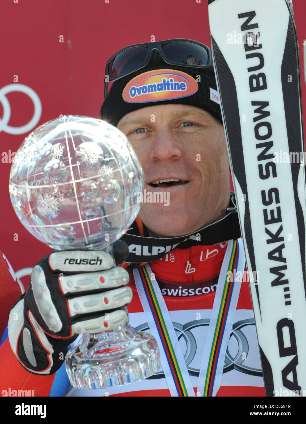 Swiss Didier Cuche celebrates with his trophy for his overall downhill ...