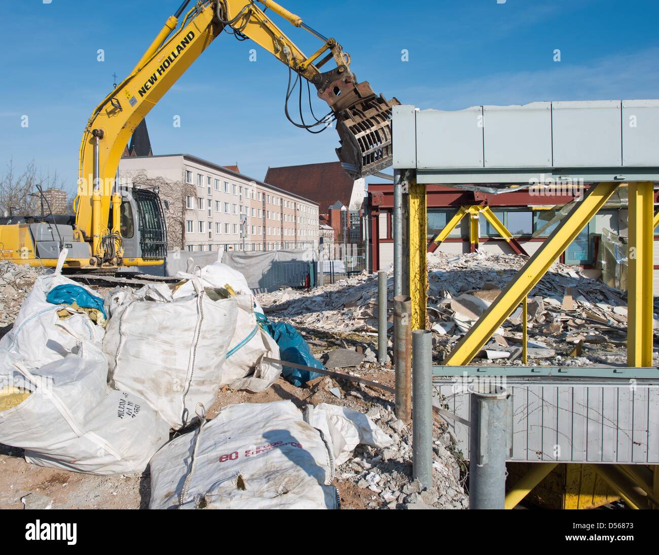 Buildings and installations are demolished with a digger at the German ...