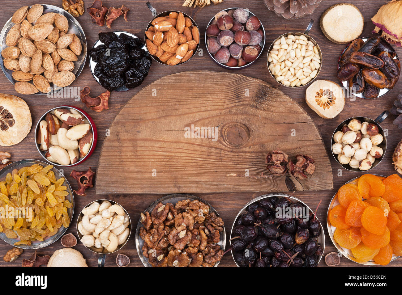 Wooden semi-circle, surrounded by nuts and fruits Stock Photo - Alamy