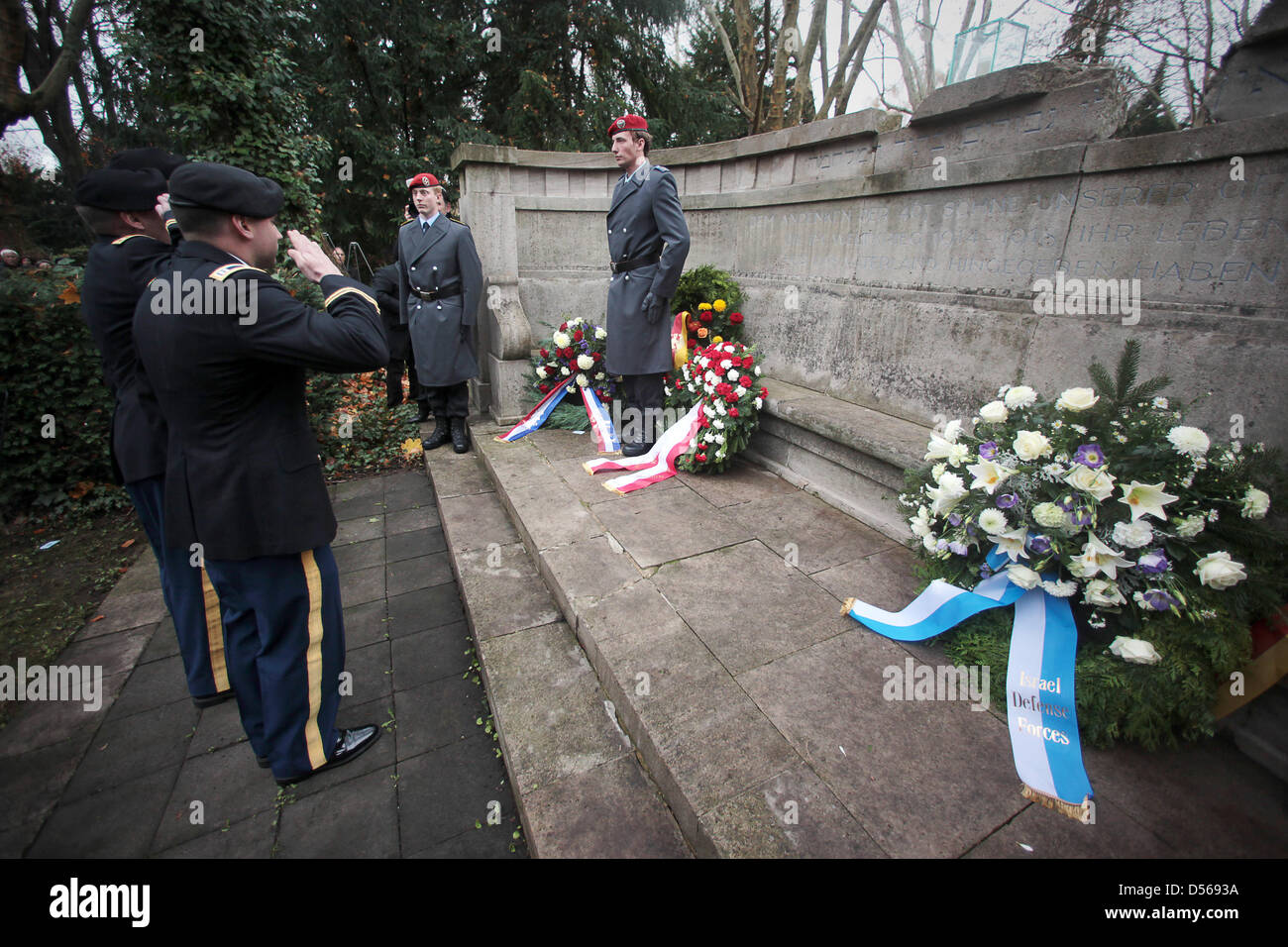 Two US soldiers salute after they laid a wreath at the Jewish cemetery ...