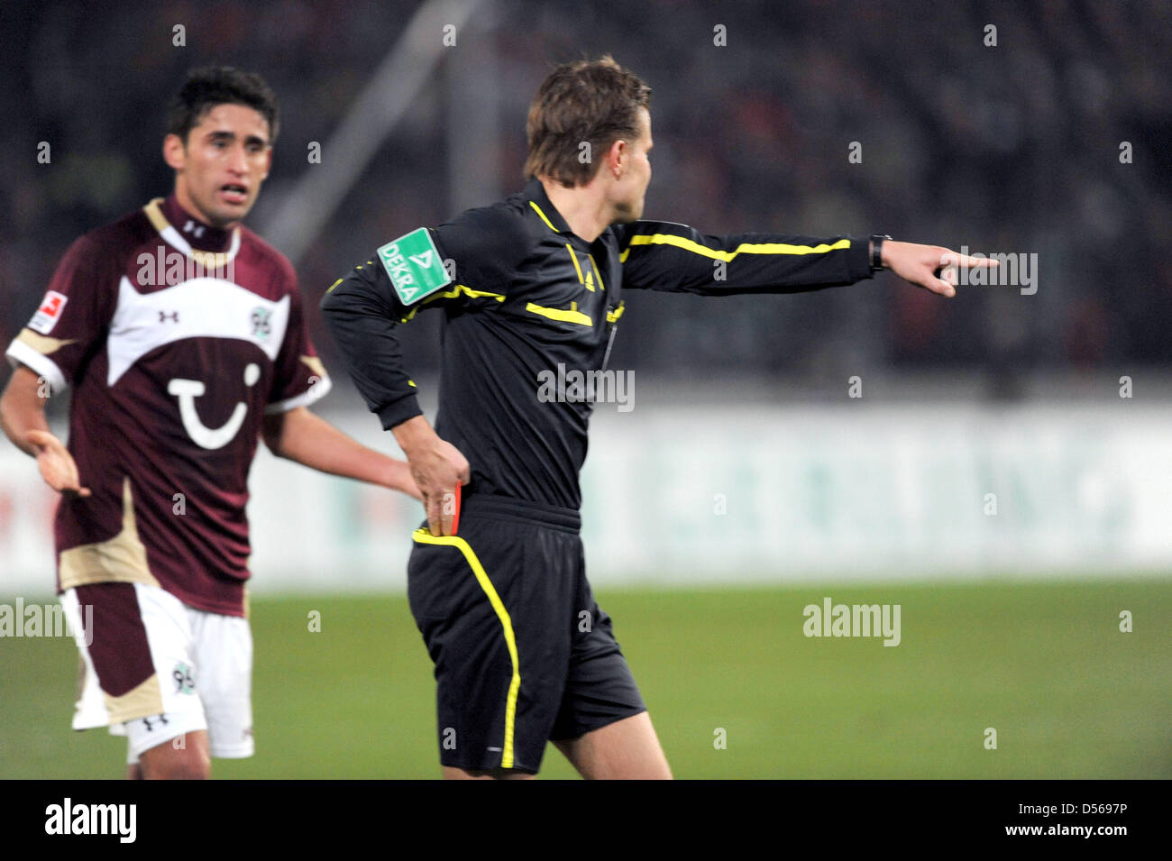 Referee Felix Byrch (R) sends off Hanover's Karim Haggui (L) during ...