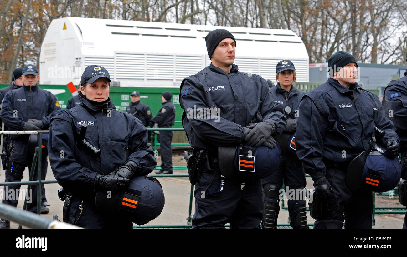 Police officers in riot gear guard the CASTOR transport arriving in ...
