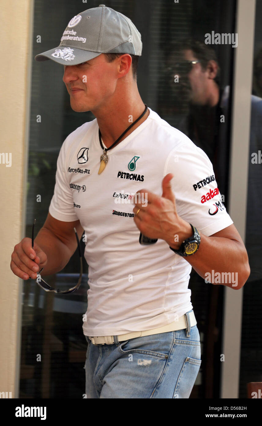 German driver Michael Schumacher of Mercedes GP arrives in the paddock ...