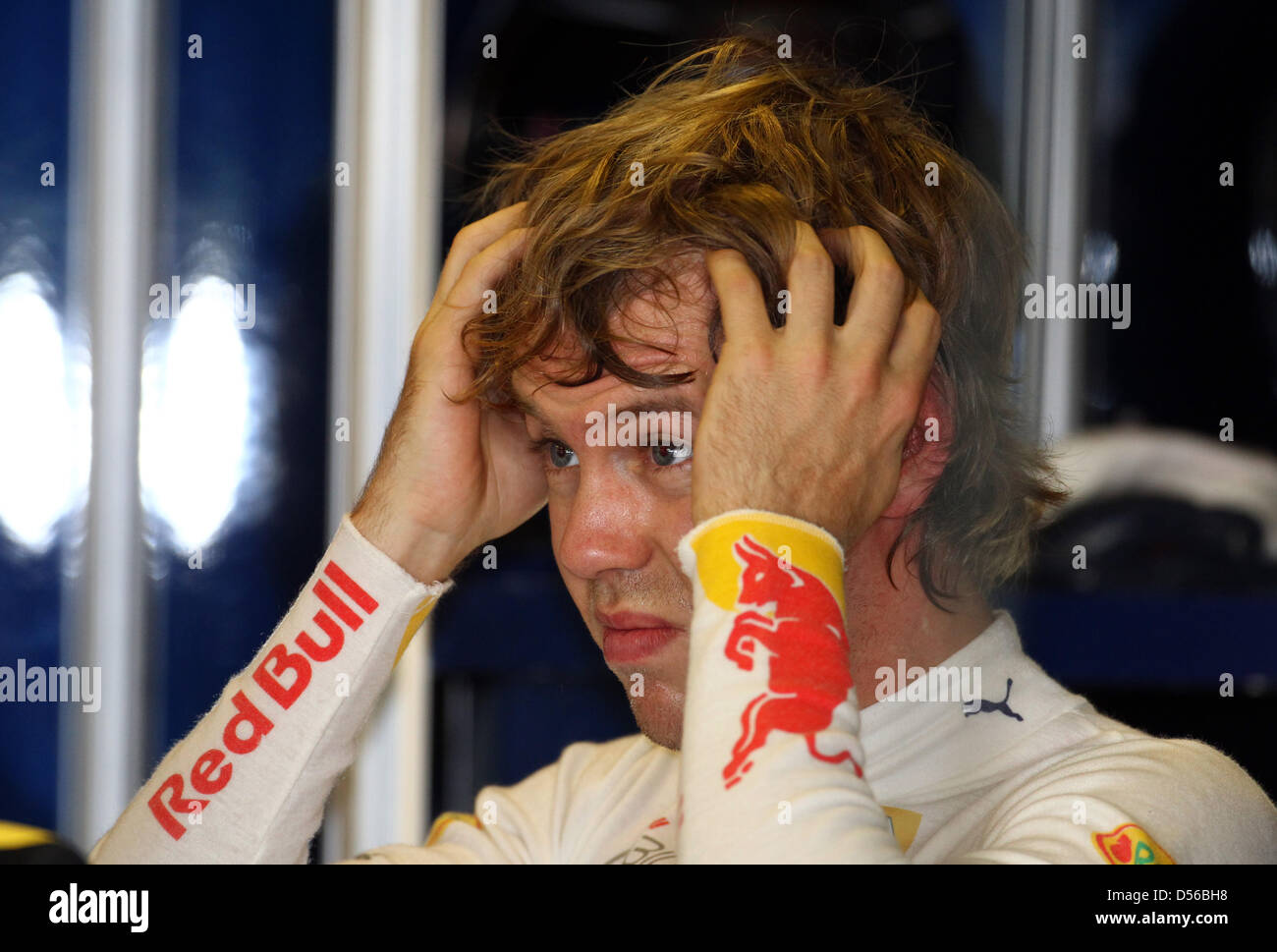 German driver Sebastian Vettel of Red Bull grabs his hair at the team's ...