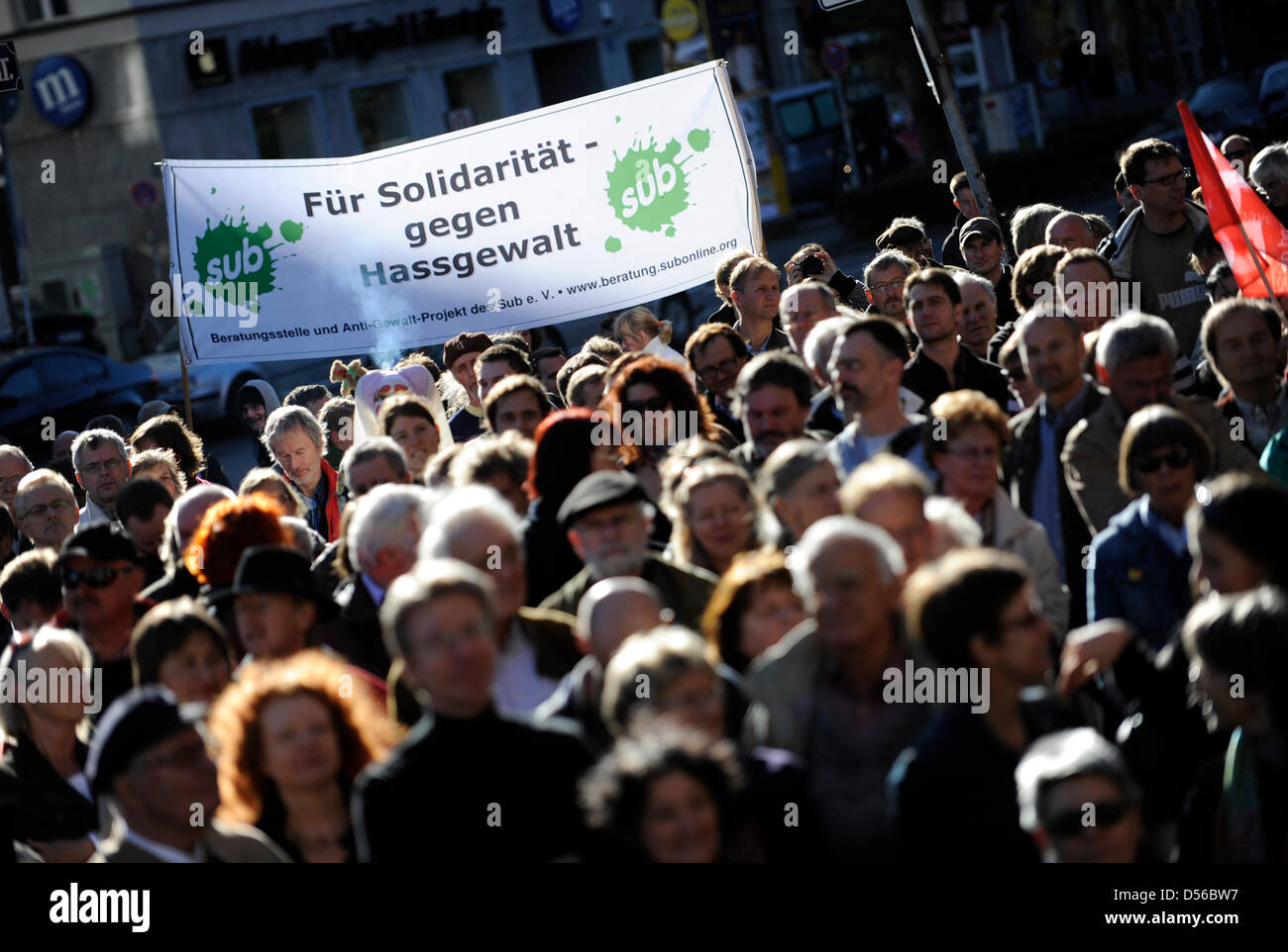 People protest with a banner reading 'For solidarity - afainst hateful ...