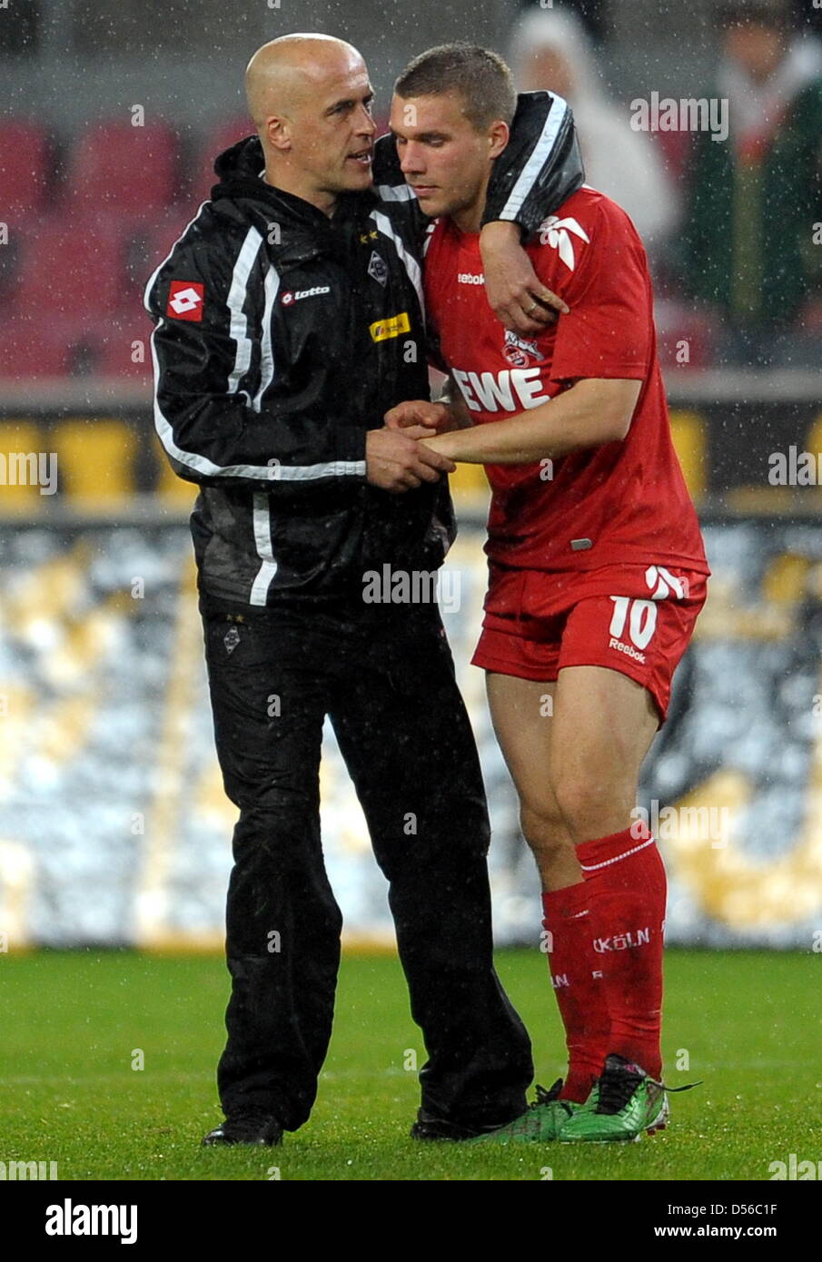 Moenchengladbach's head coach Michael Frontzeck (L) consoles Cologne's ...