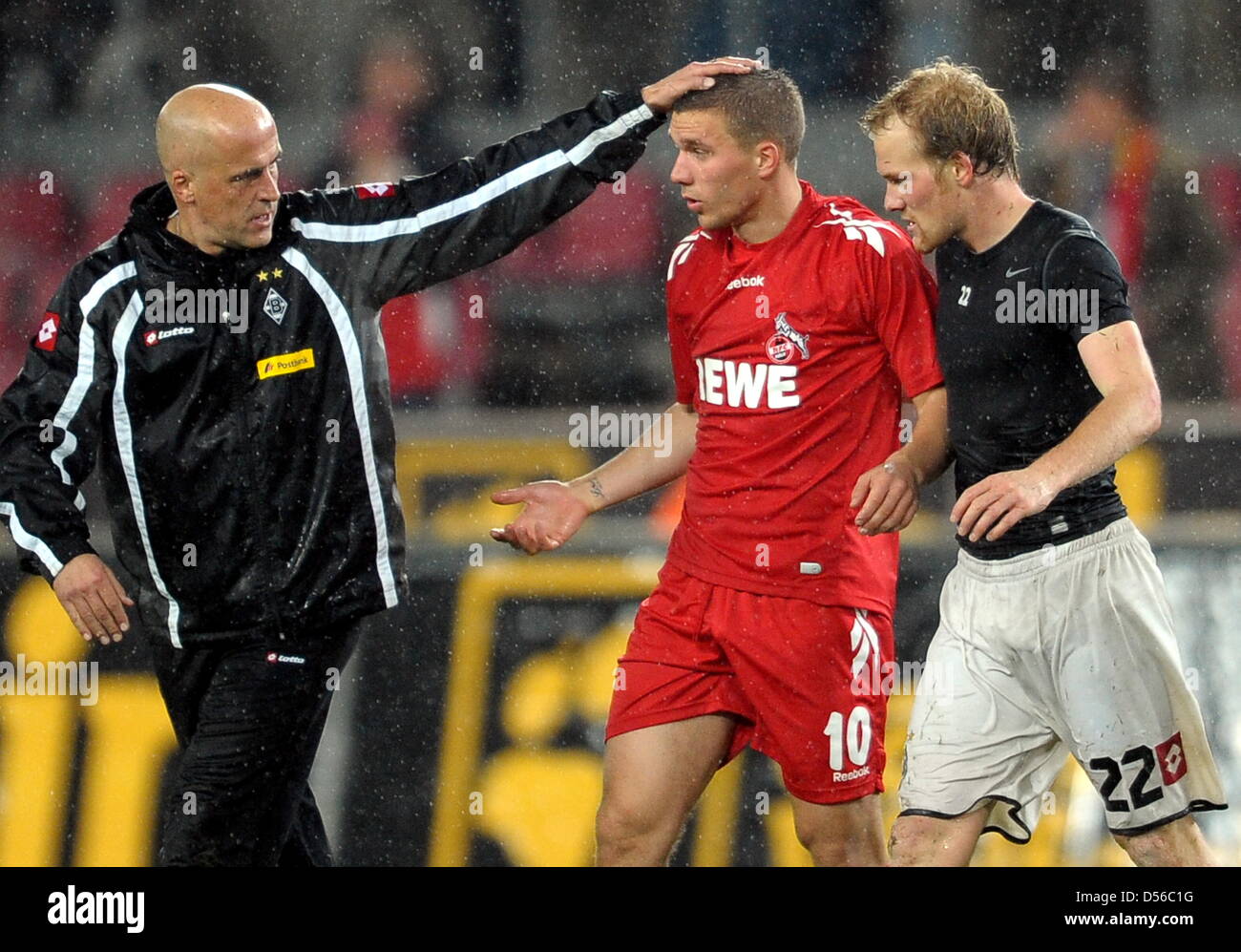 Moenchengladbach's head coach Michael Frontzeck (L) consoles Cologne's ...