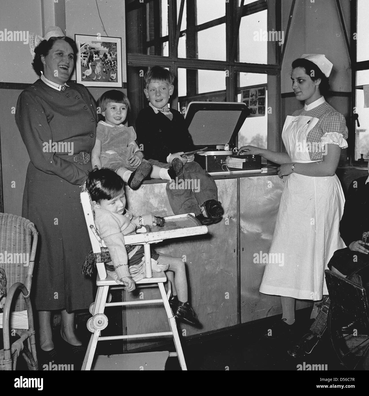 Historical 1950s. England. On a pediatric hospital ward, a matron and ...