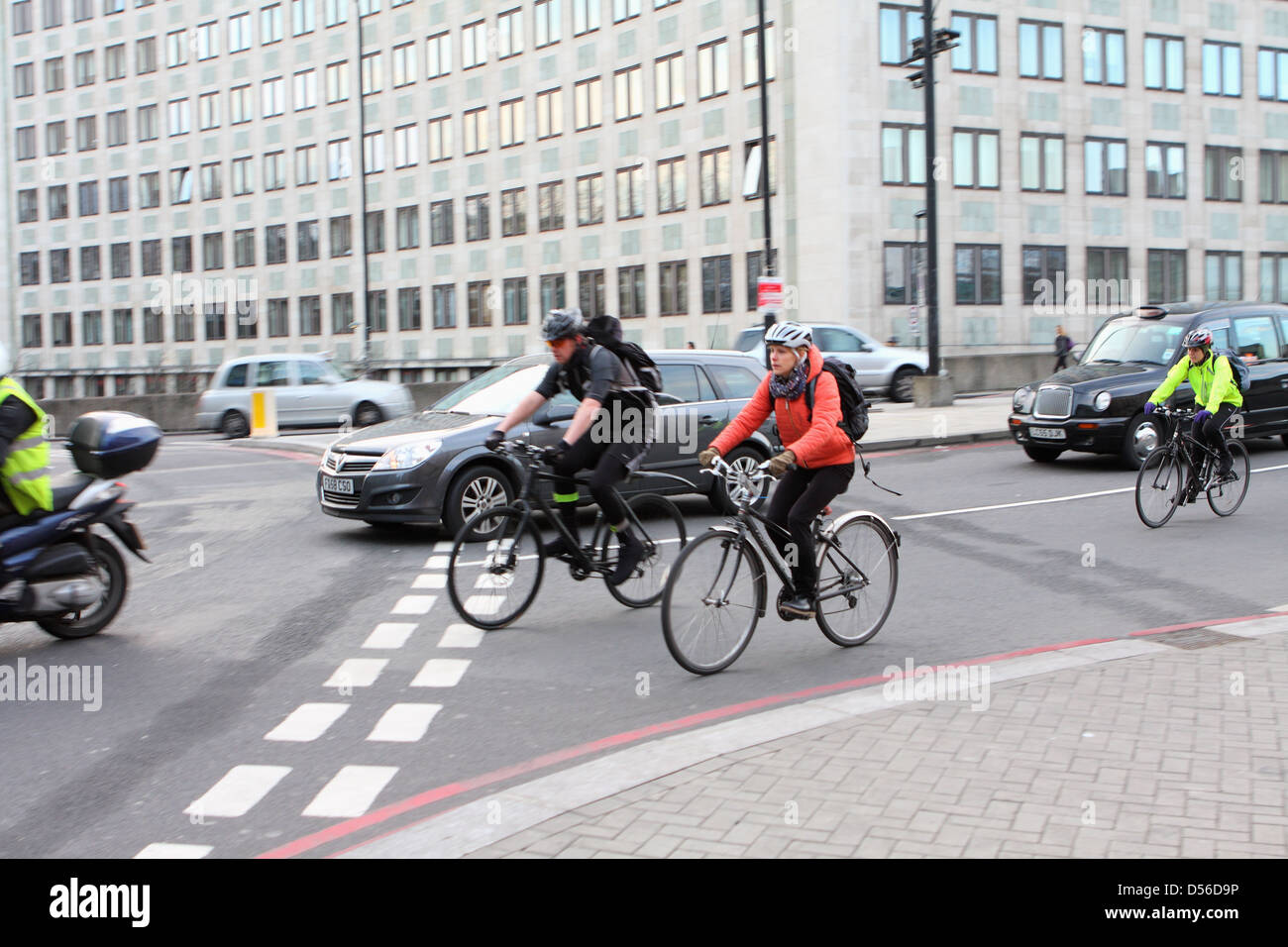 Cyclists and traffic entering a roundabout in London, England Stock ...