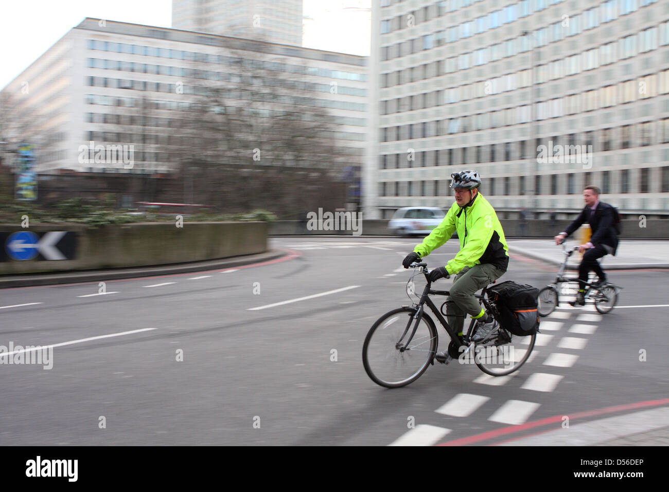 Two cyclists entering a roundabout in London, England Stock Photo - Alamy