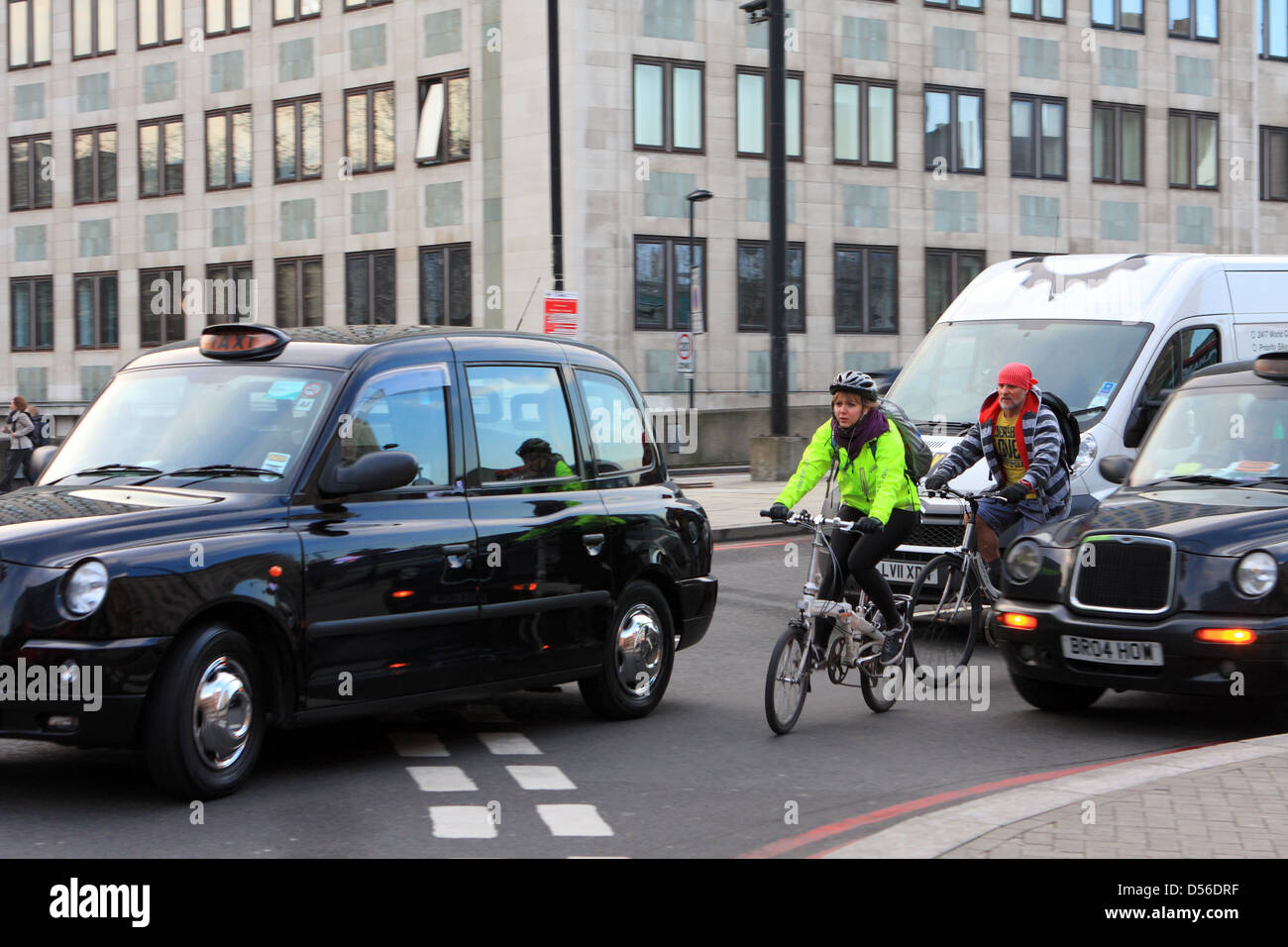 Cyclists and traffic entering a roundabout in London, England Stock ...