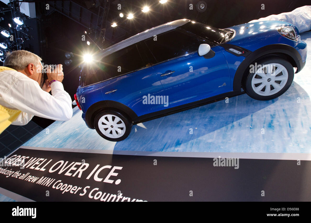 A visitor takes pictures of a Mini Cooper S Countryman at a booth of ...