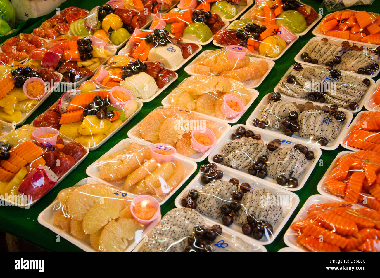 Tropical fresh fruits cut and wrapped on the market in Krabi Town ...