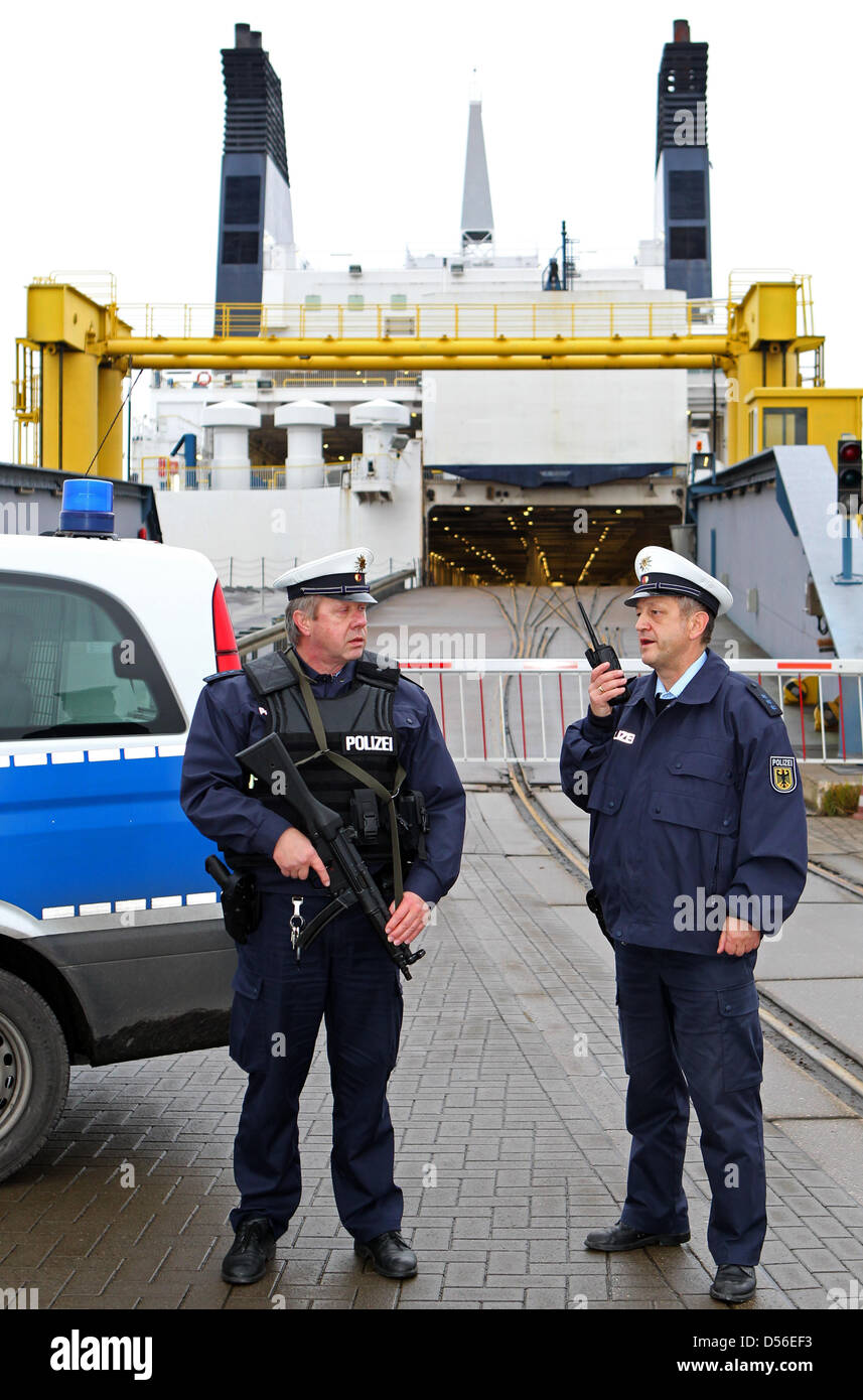 Police officers are on patrol in front of the Scandinavian ferry that ...