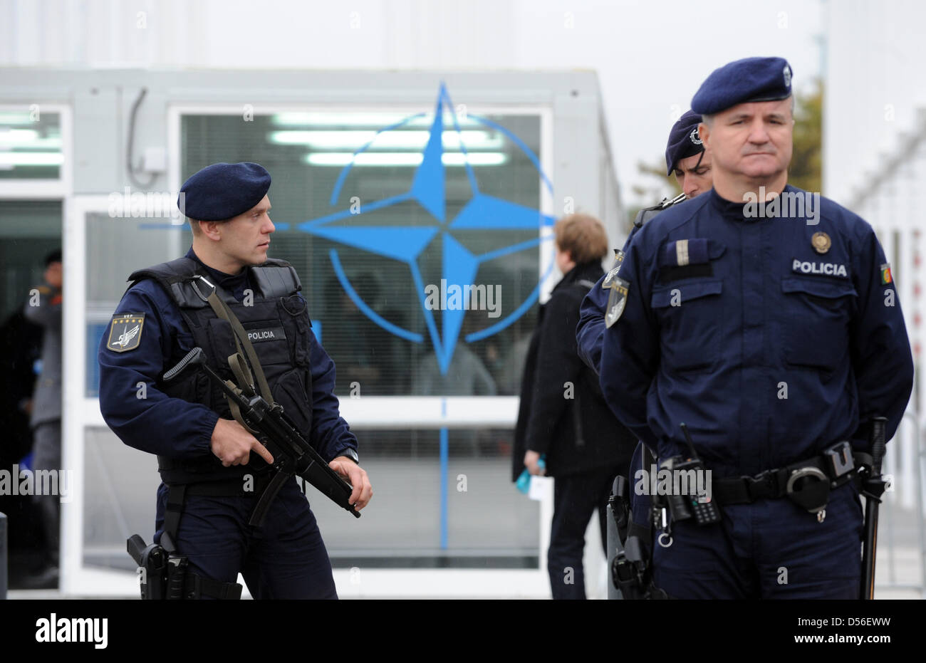 Police officers monitor the premises of the NATO Summit in Lisbon ...